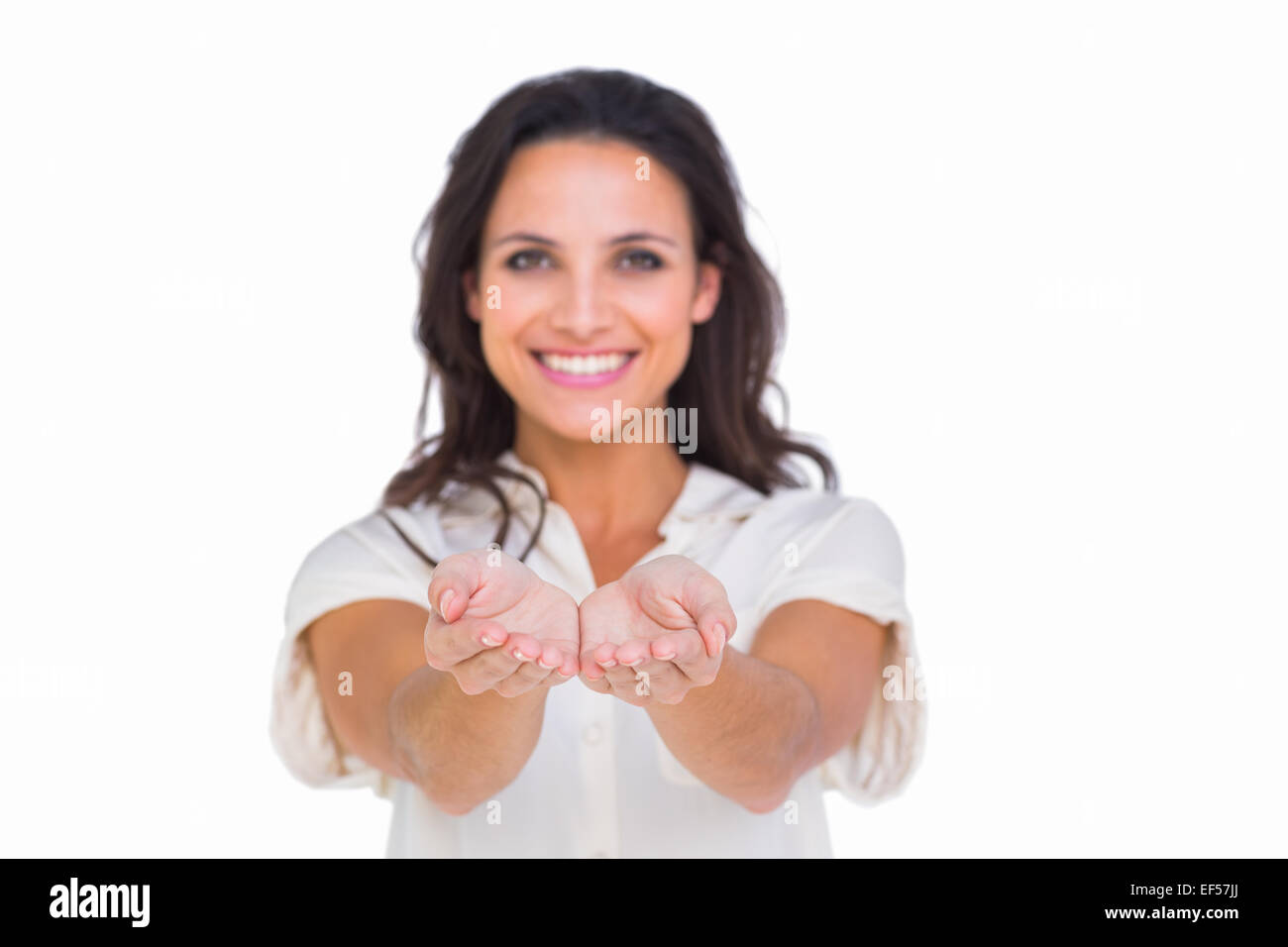 Pretty brunette with hands out Stock Photo - Alamy