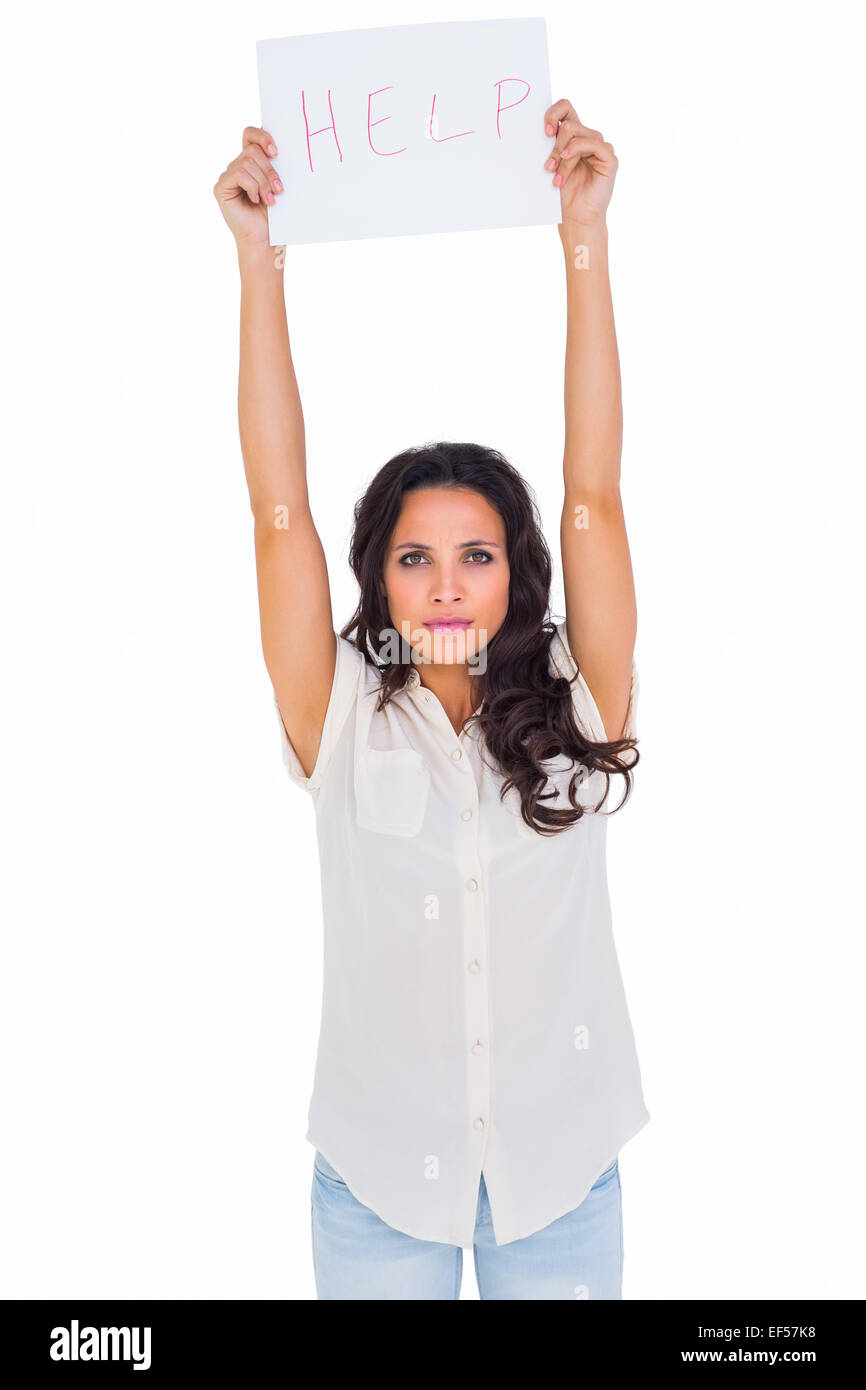 Brunette holding up help sign Stock Photo - Alamy