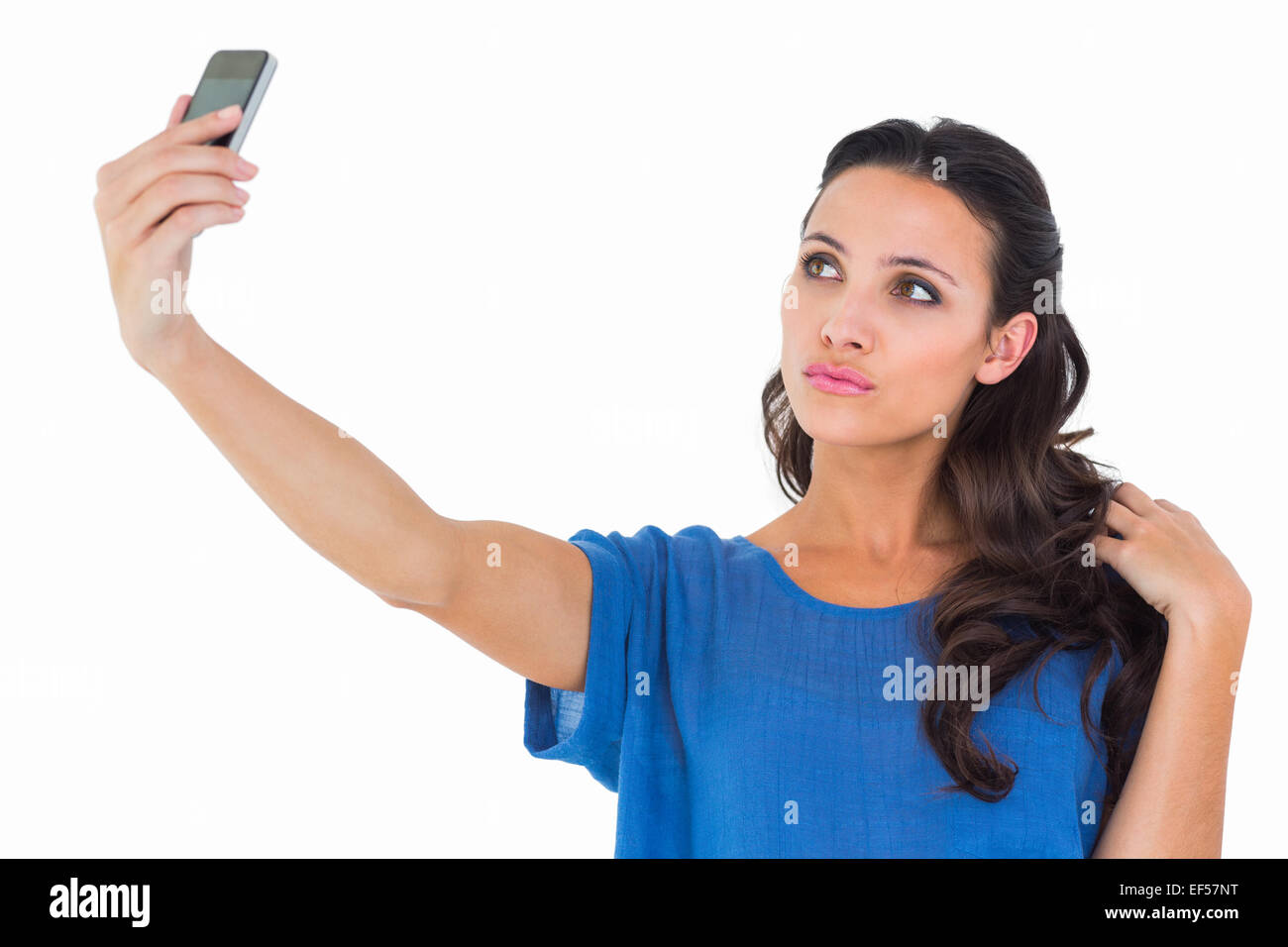 Pretty brunette taking a selfie Stock Photo - Alamy