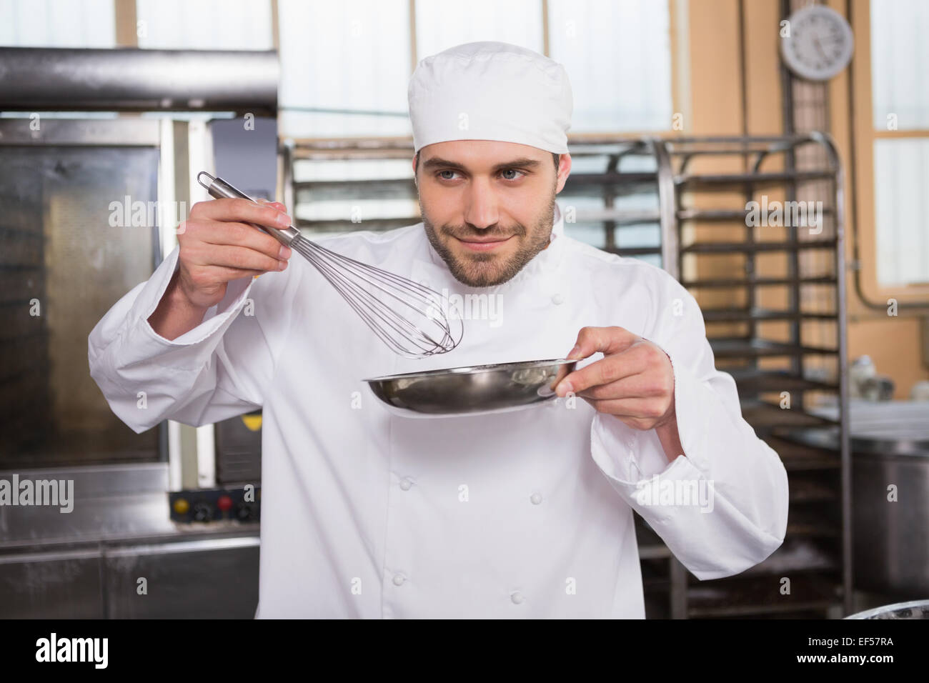 Smiling baker preparing a pastry Stock Photo - Alamy
