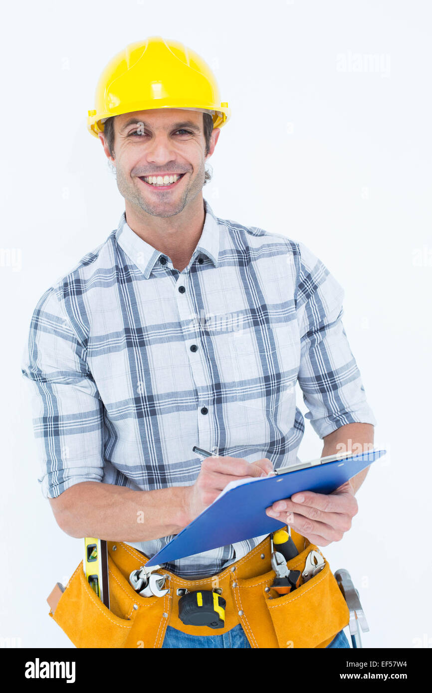 Happy architect writing notes on clip board Stock Photo - Alamy