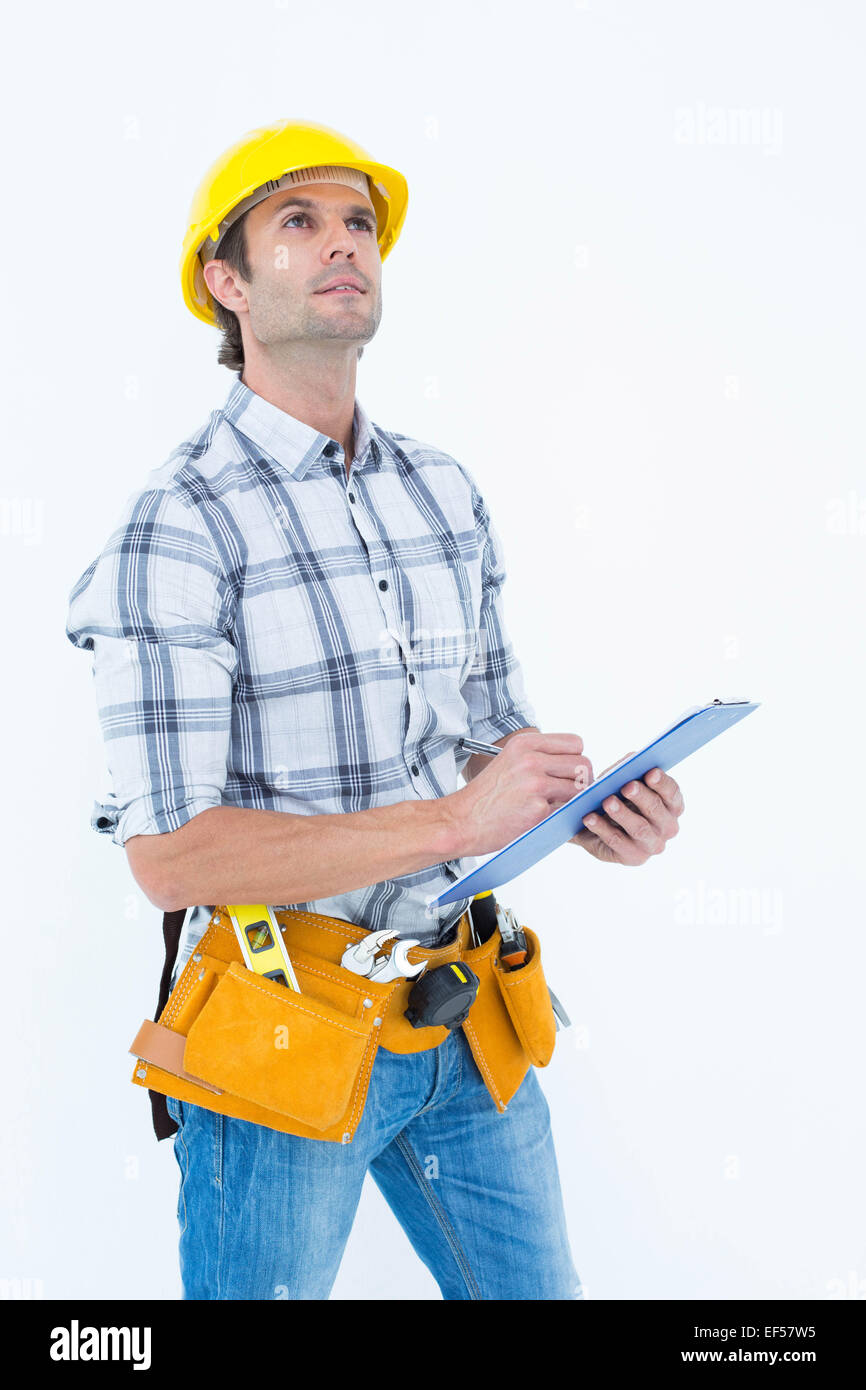 Handsome architect writing notes on clip board Stock Photo - Alamy