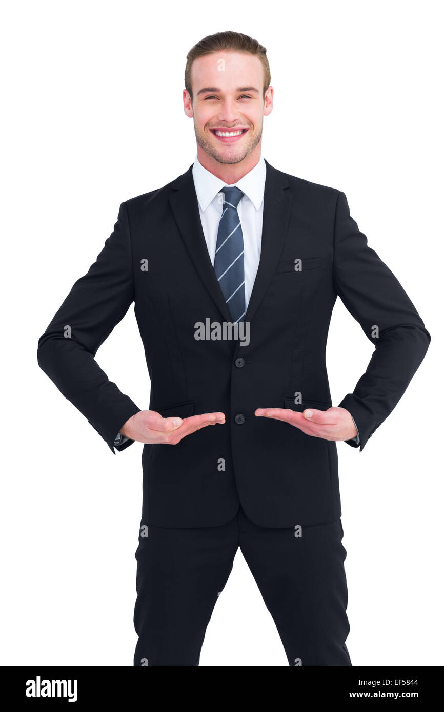 Happy businessman standing with hands out Stock Photo - Alamy