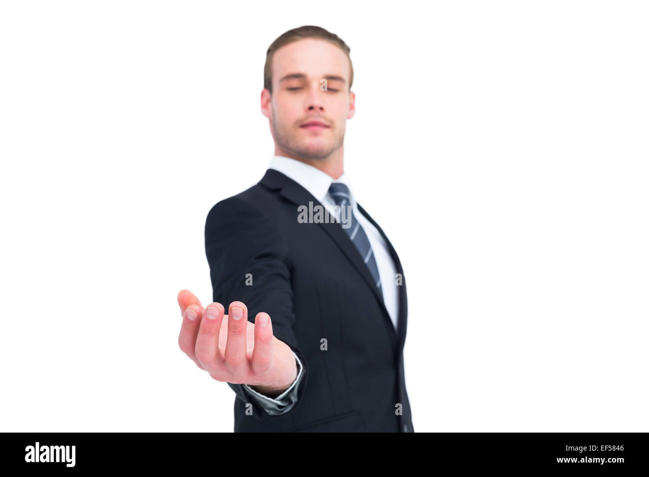 Serious businessman holding out his hand Stock Photo - Alamy