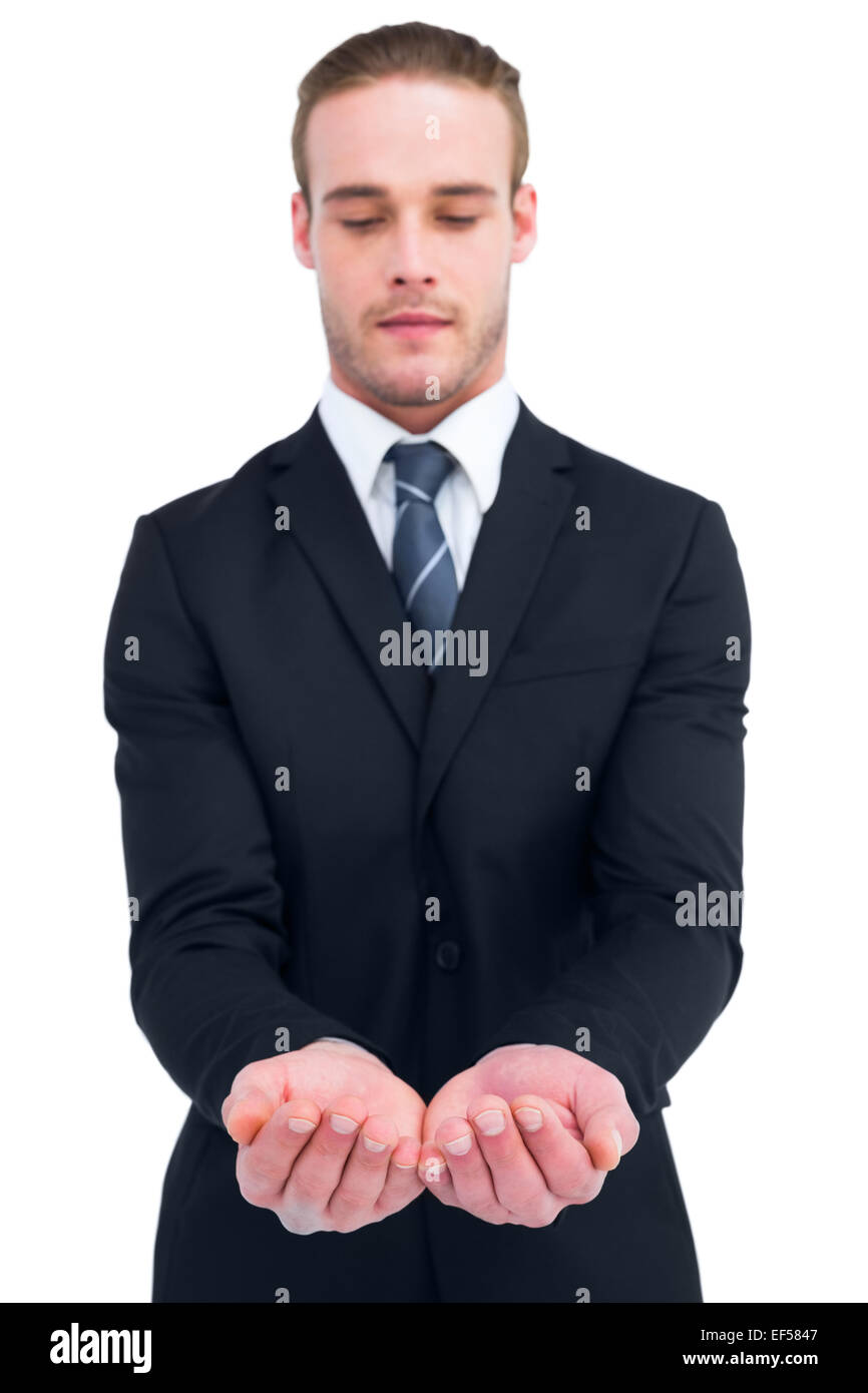 Concentrated businessman holding out his hands Stock Photo - Alamy