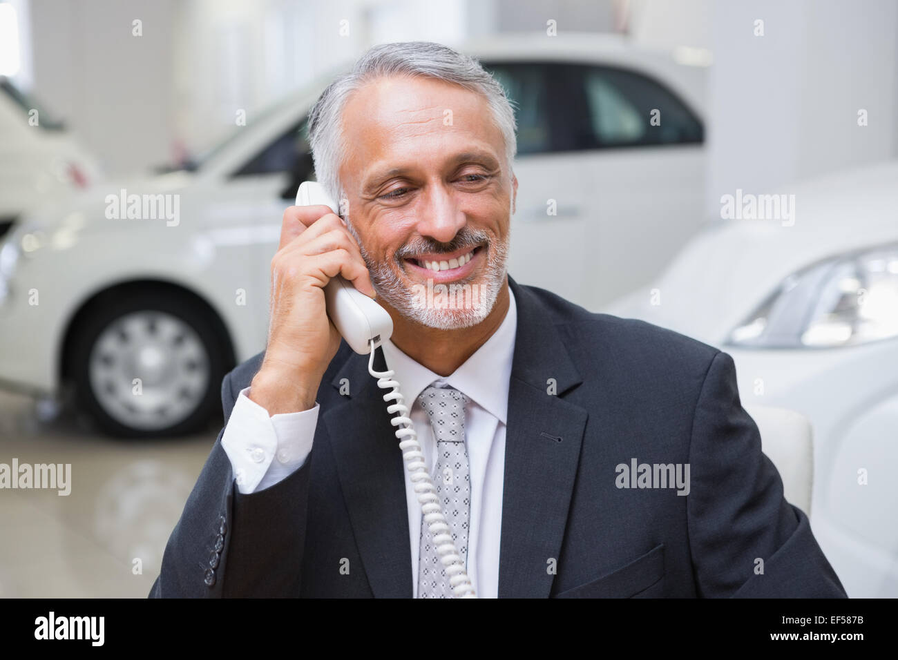 Smiling businessman making a phone call Stock Photo - Alamy