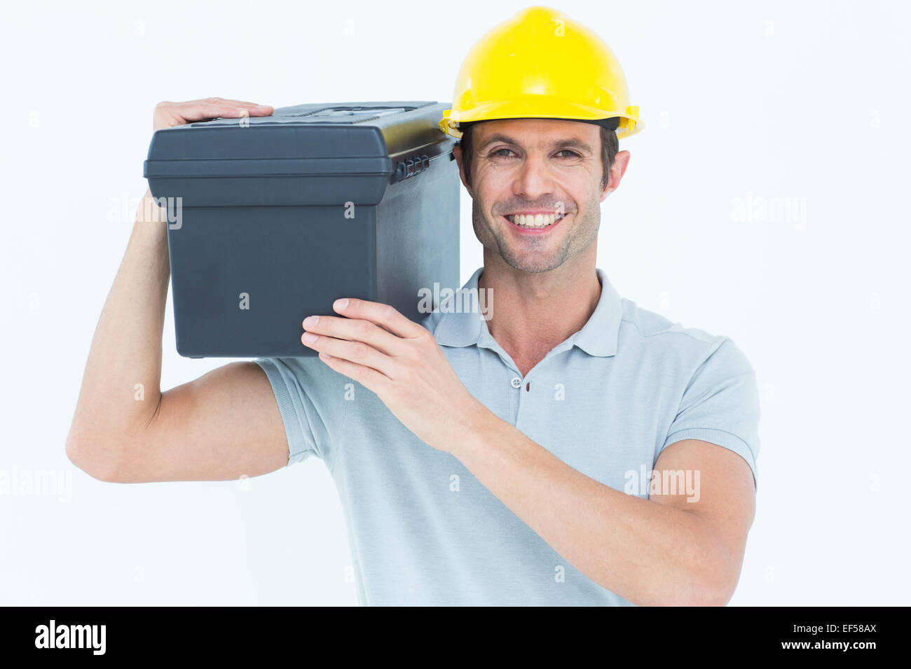 Happy worker carrying tool box on shoulder Stock Photo - Alamy