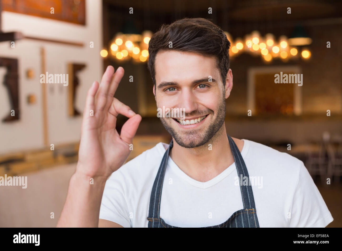 Handsome waiter smiling at camera Stock Photo - Alamy