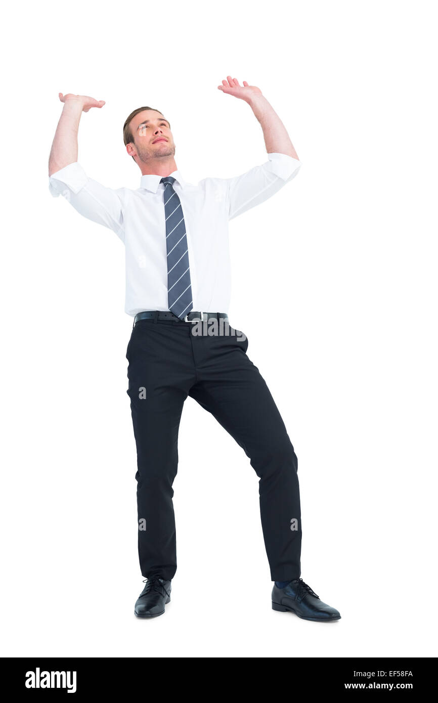 Businessman bending and pushing Stock Photo - Alamy