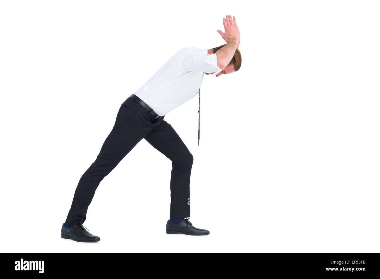 Businessman bending and pushing Stock Photo - Alamy