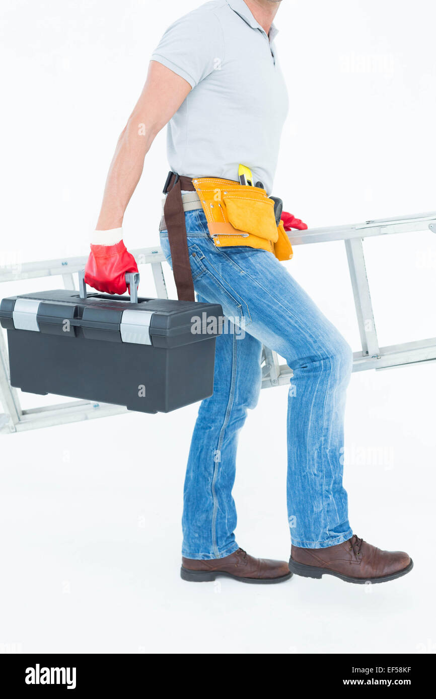 Worker carrying step ladder and tool box Stock Photo - Alamy