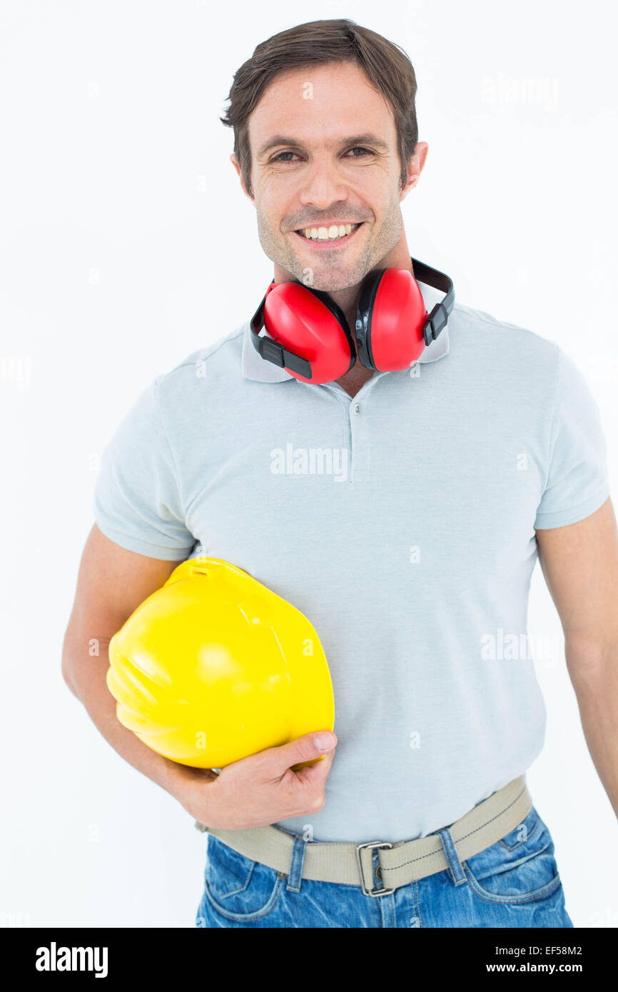 Happy carpenter with hard hat and ear protectors Stock Photo - Alamy
