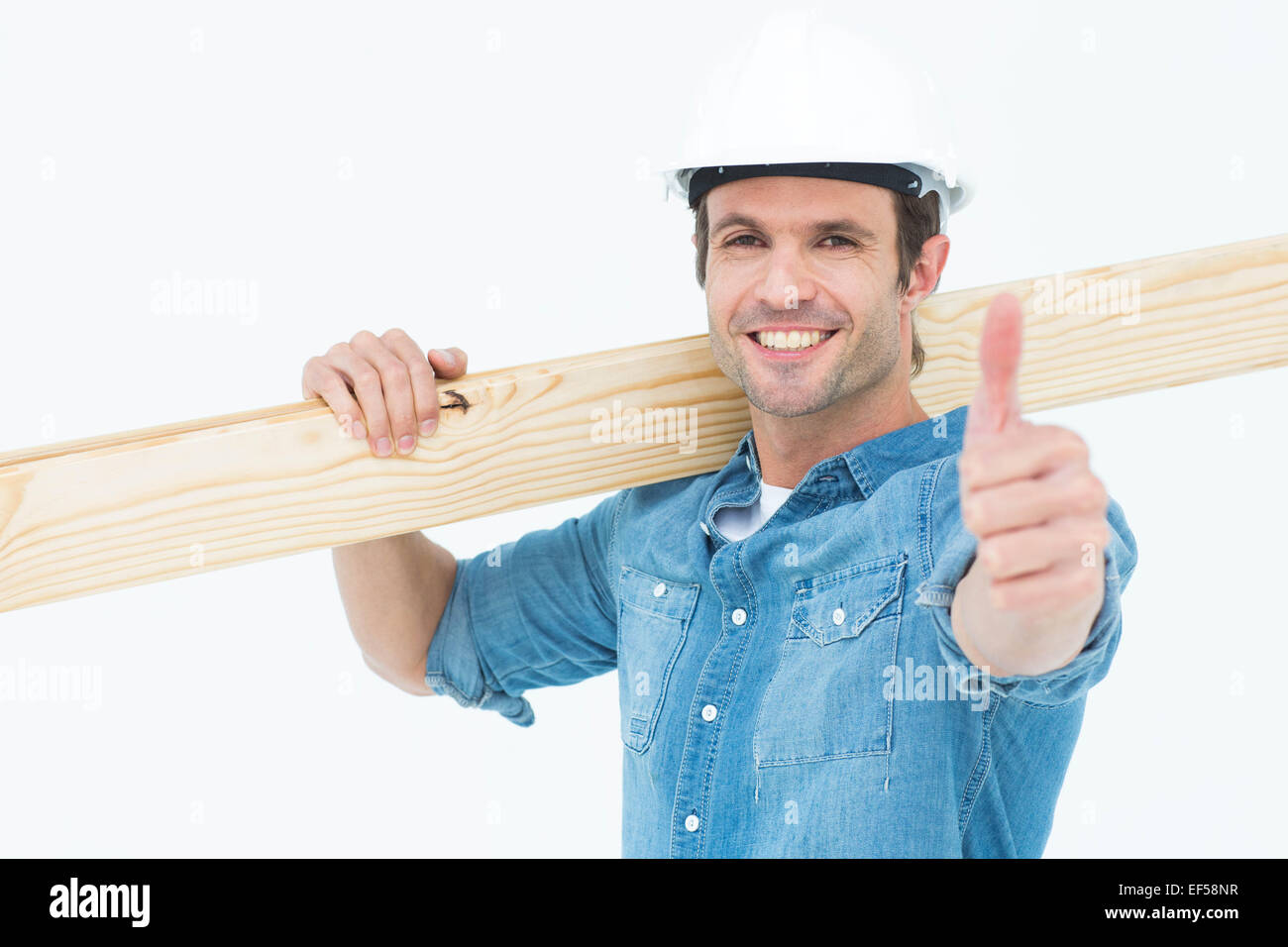 Confident carpenter carrying wooden plank Stock Photo - Alamy