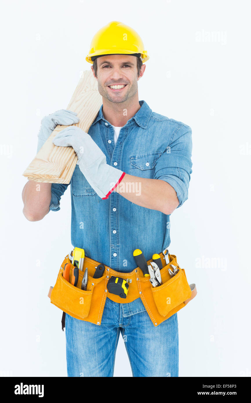 Happy carpenter carrying wooden planks Stock Photo - Alamy