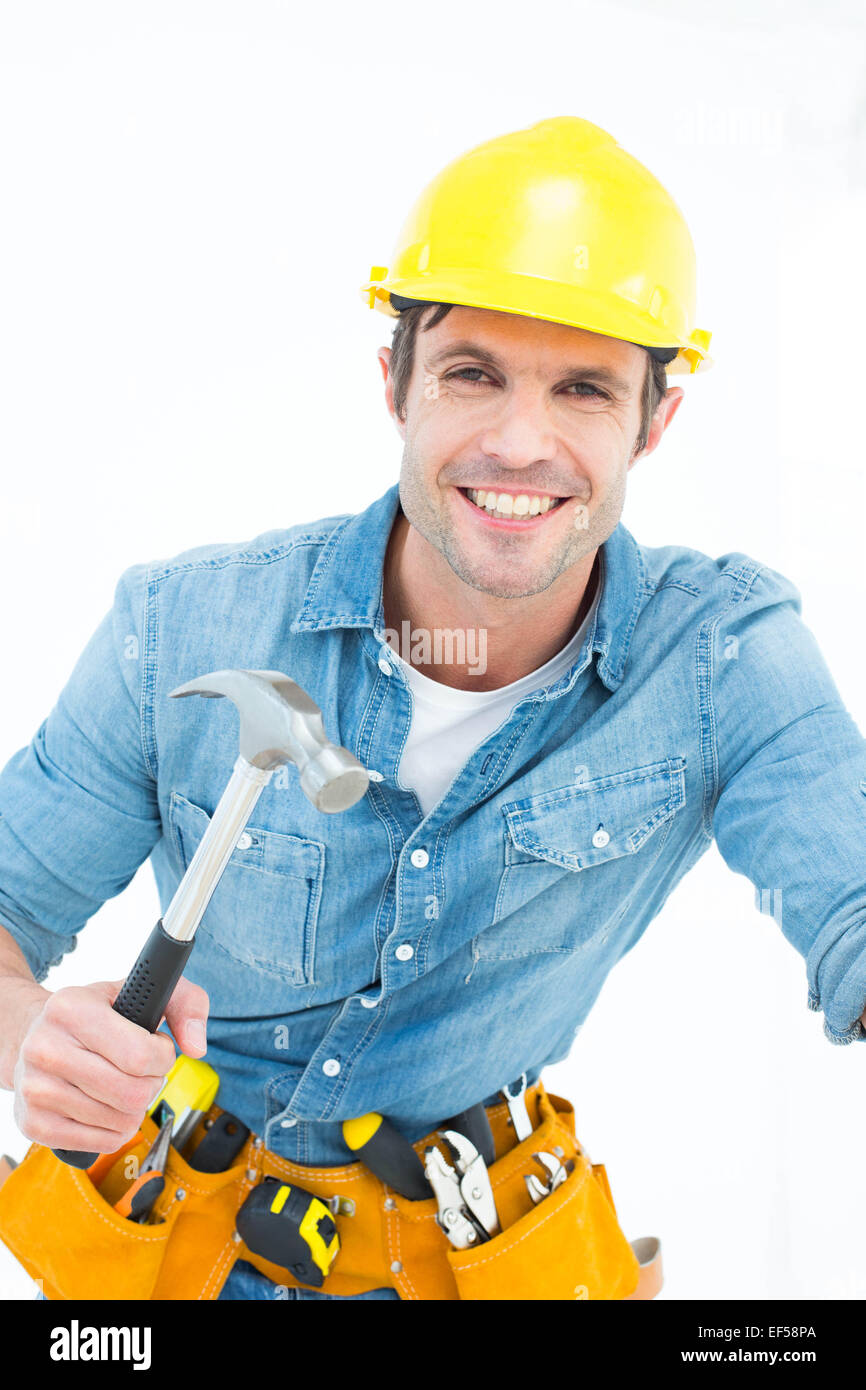 Confident carpenter using hammer Stock Photo - Alamy