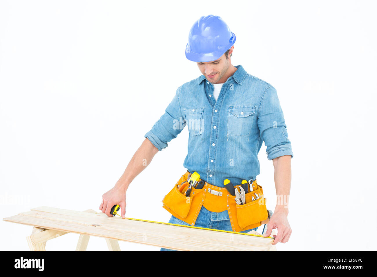 Carpenter measuring wooden plank Stock Photo - Alamy