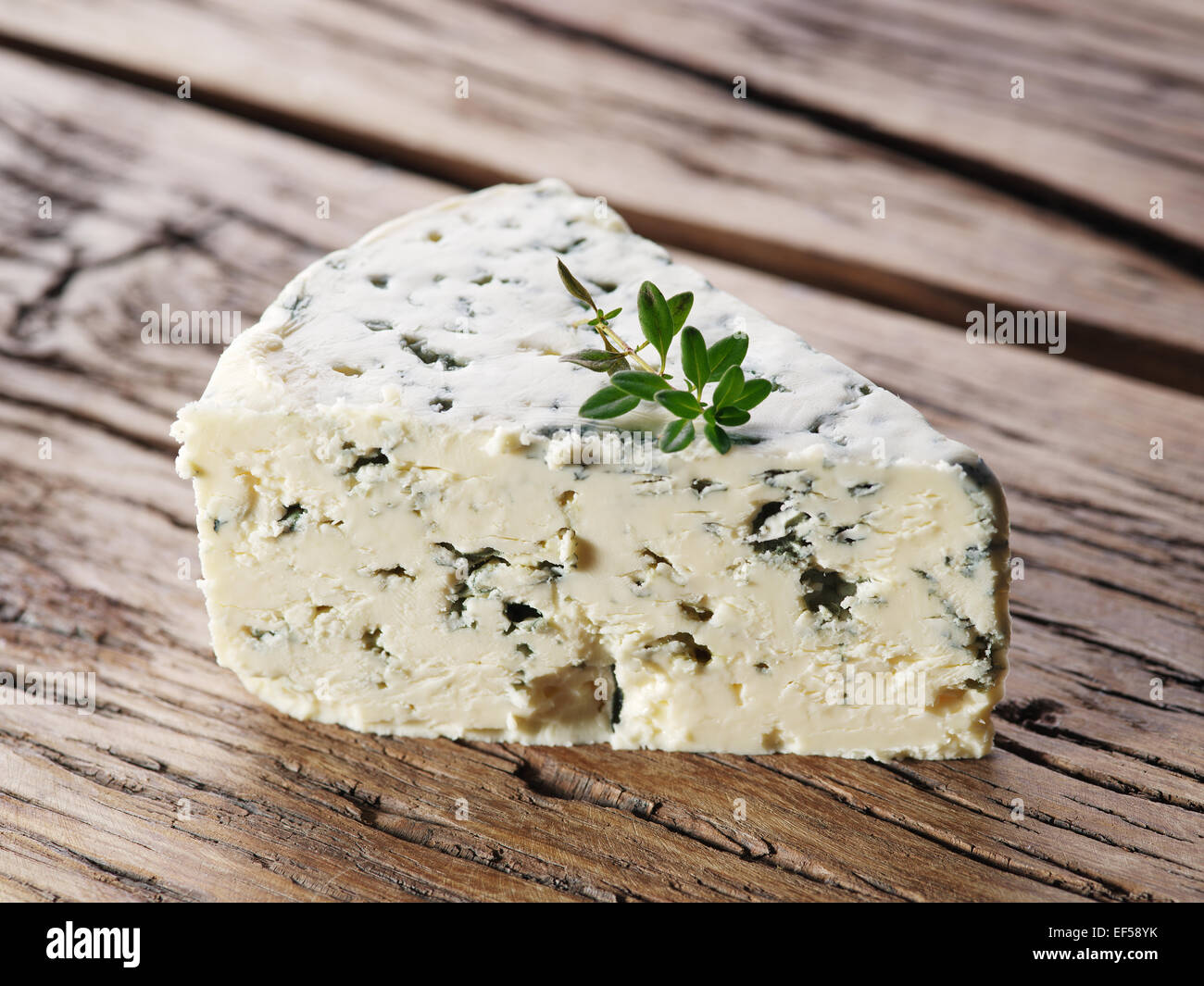 Slices of Danish Blue cheese on an old wooden table Stock Photo - Alamy