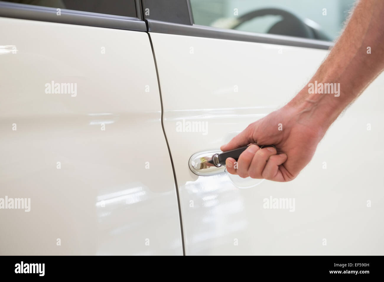Man opening a car with a key Stock Photo - Alamy