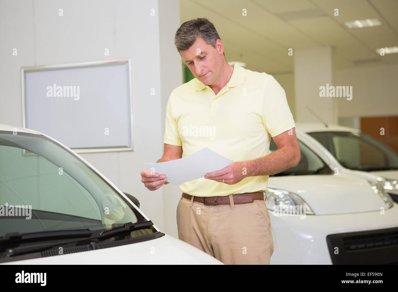 Focused customer reading a booklet Stock Photo - Alamy