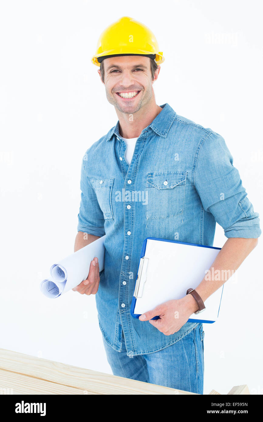 Happy carpenter holding rolled blueprint and clipboard Stock Photo - Alamy