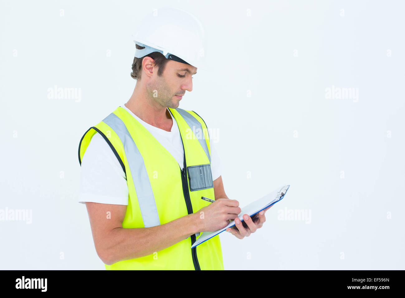 Worker writing notes on clipboard Stock Photo - Alamy