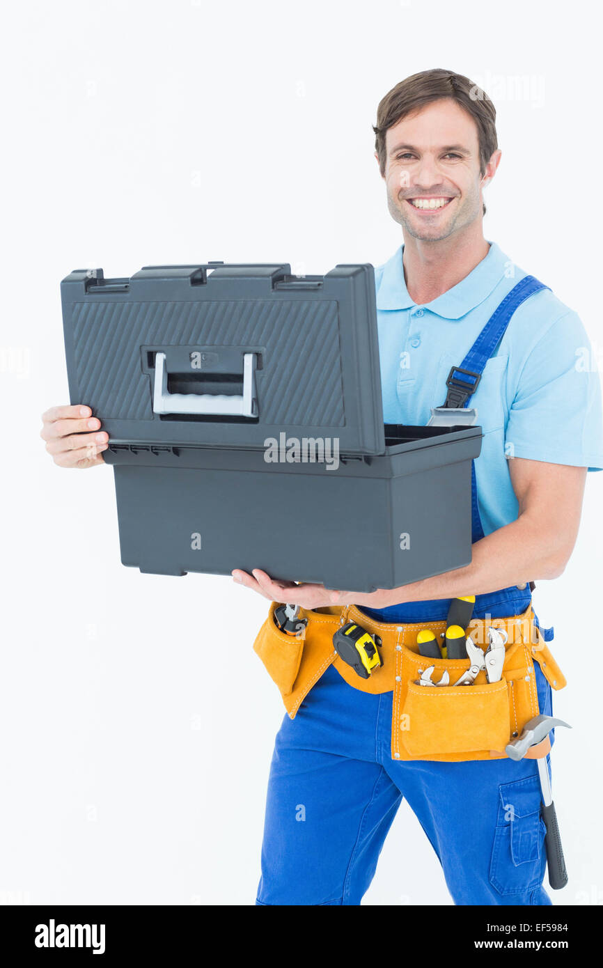 Confident carpenter opening tool box Stock Photo - Alamy