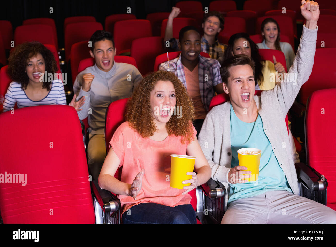 Young people watching a film Stock Photo - Alamy
