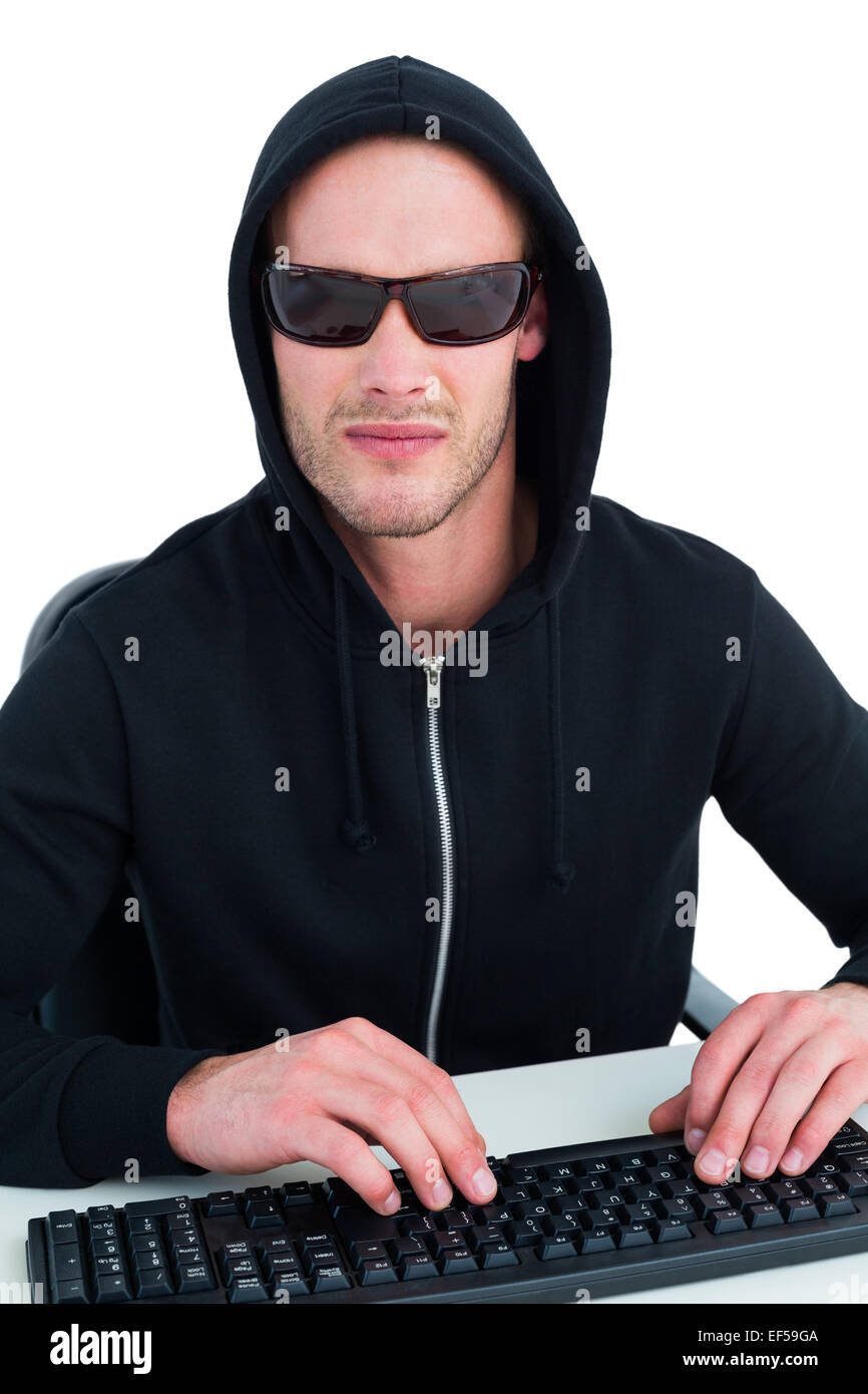 Stern hacker with sunglasses typing on keyboard Stock Photo - Alamy