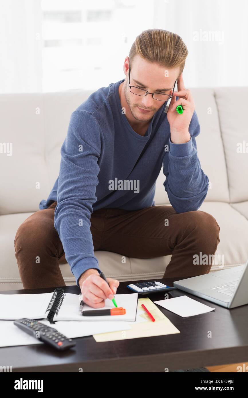 Concentrated man with glasses taking notes Stock Photo - Alamy