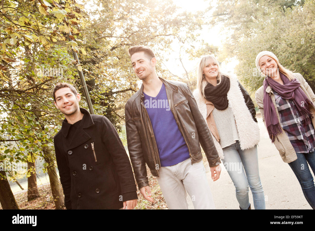 Group of friends walking outdoors Stock Photo - Alamy