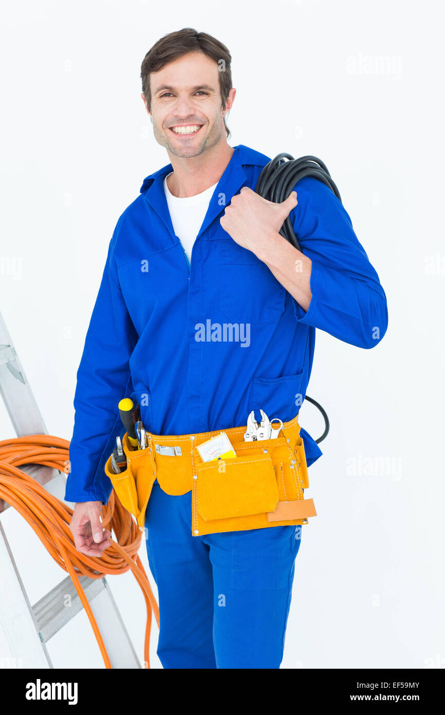 Happy electrician with wires over white background Stock Photo - Alamy