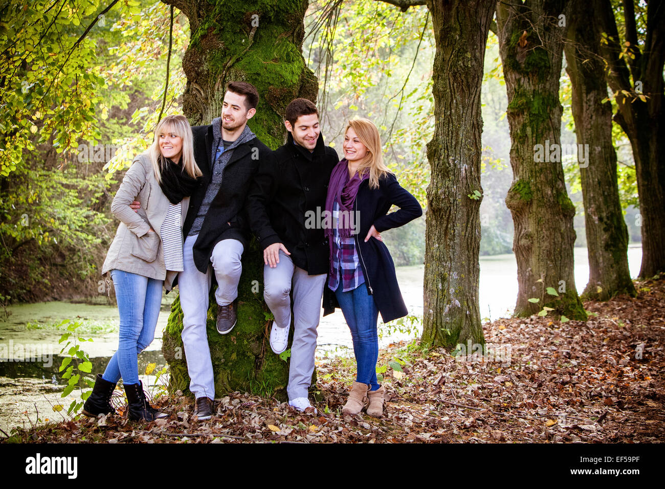 Group of friends standing together in alley Stock Photo - Alamy