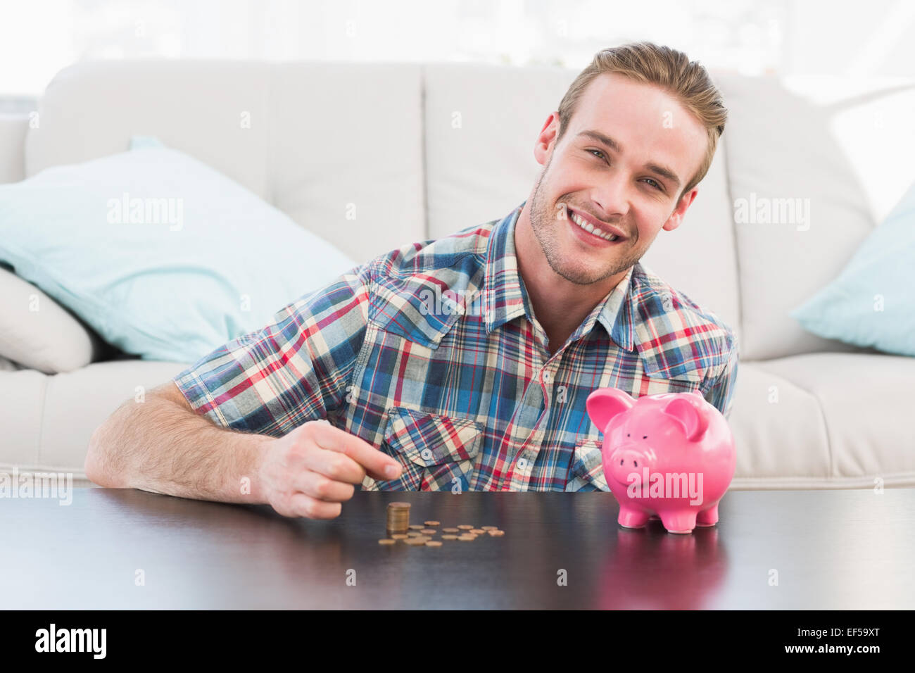 A smiling man holding a pennie Stock Photo - Alamy