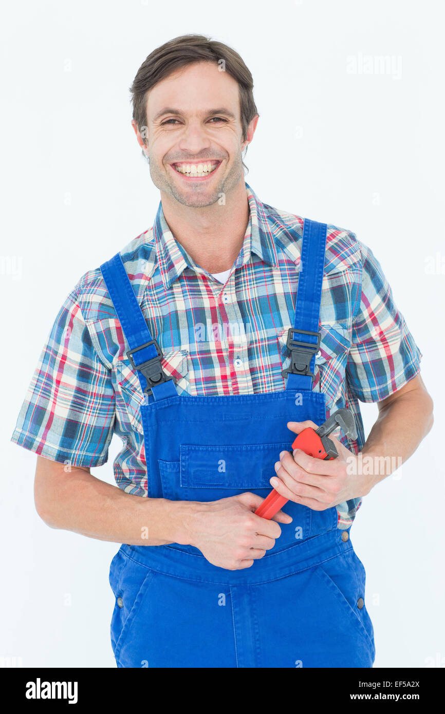 Friendly handyman is holding an adjustable wrench hi-res stock ...