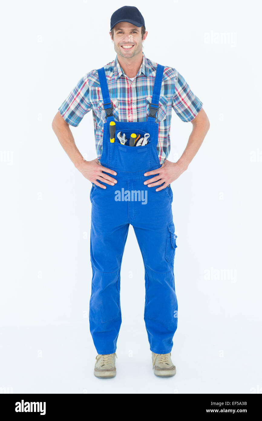 Portrait of confident plumber with hands on hip Stock Photo - Alamy