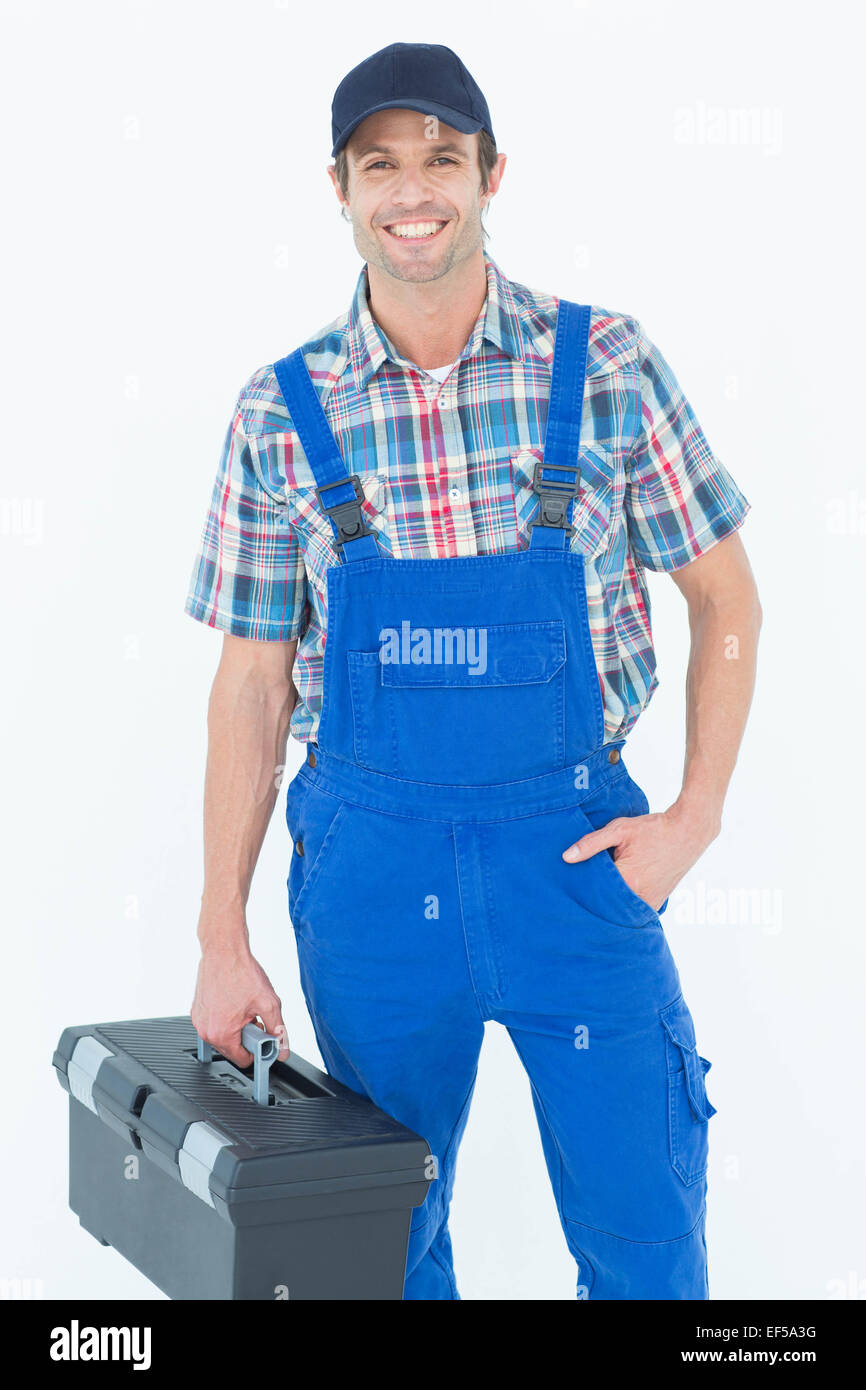 Confident plumber carrying tool box Stock Photo - Alamy