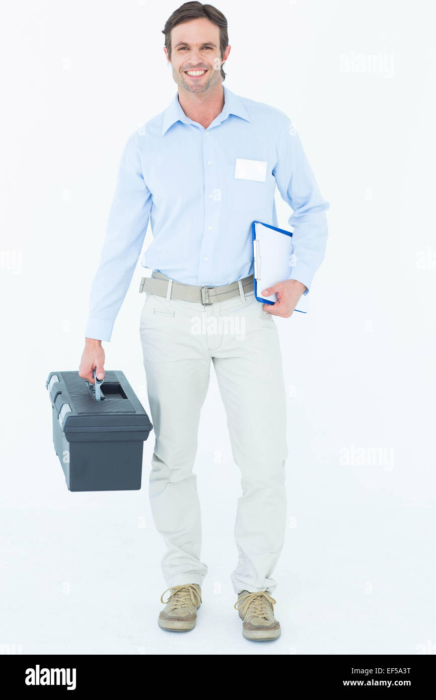 Happy supervisor carrying tool box and clipboard Stock Photo - Alamy
