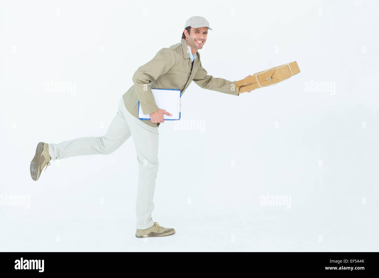 Happy delivery man running while holding parcel Stock Photo - Alamy