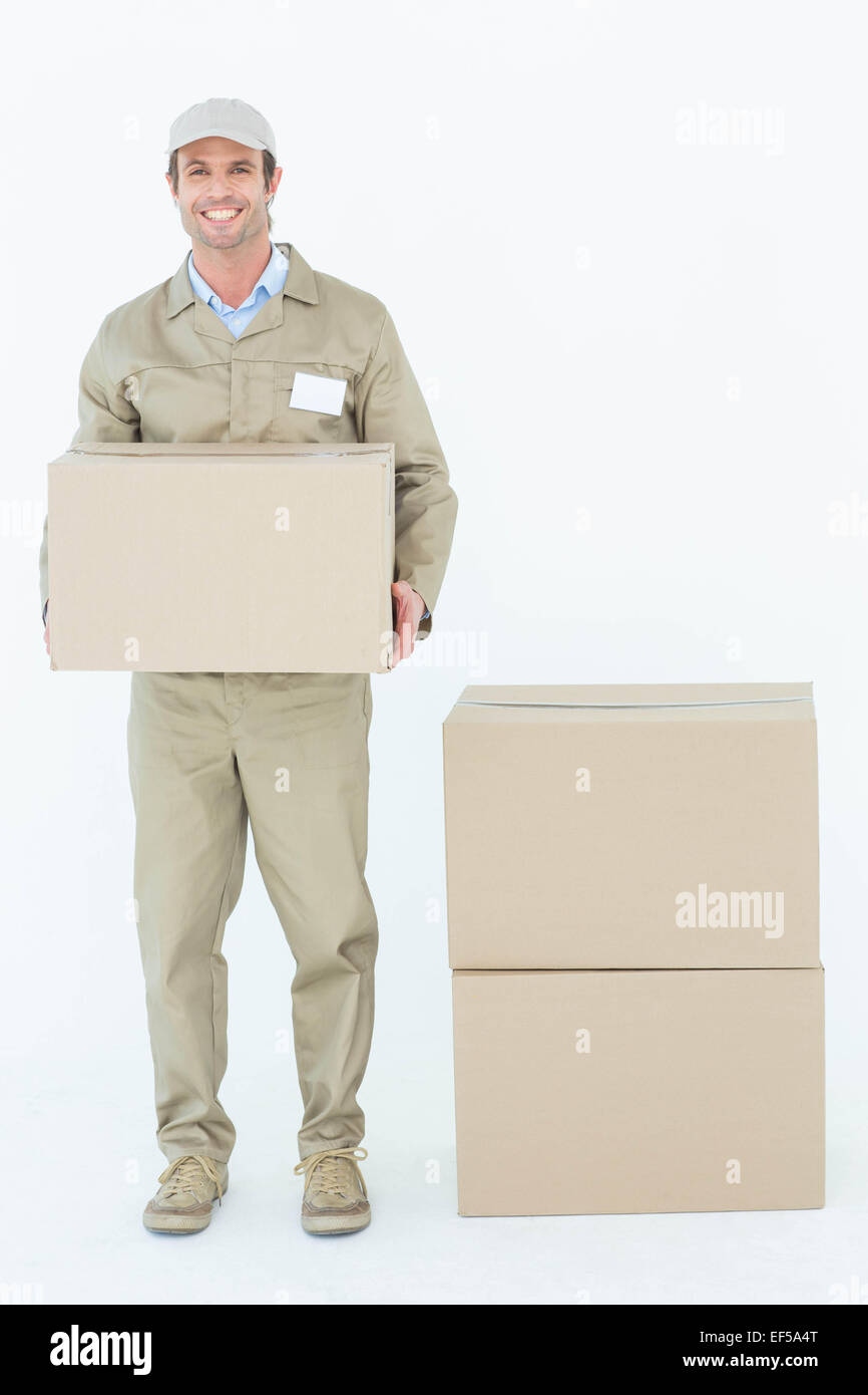 Happy delivery man carrying cardboard box Stock Photo - Alamy