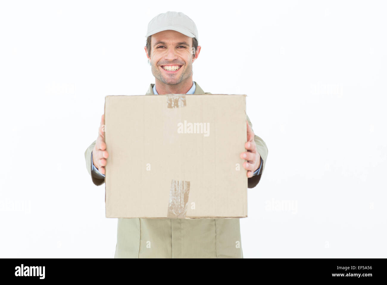 Happy delivery man carrying parcel Stock Photo - Alamy