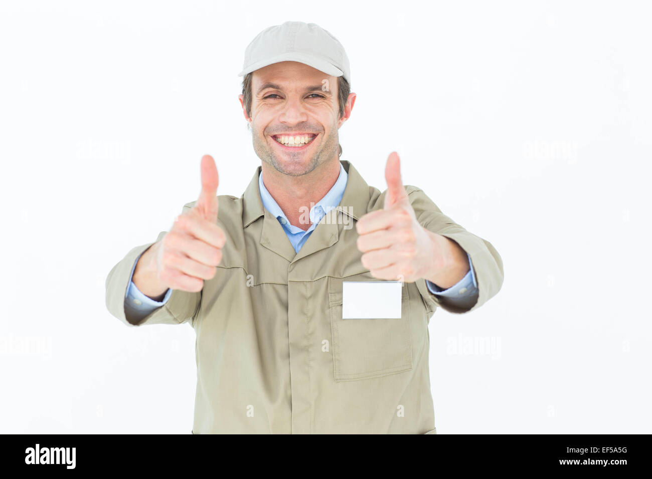 Happy delivery man gesturing thumbs up Stock Photo - Alamy