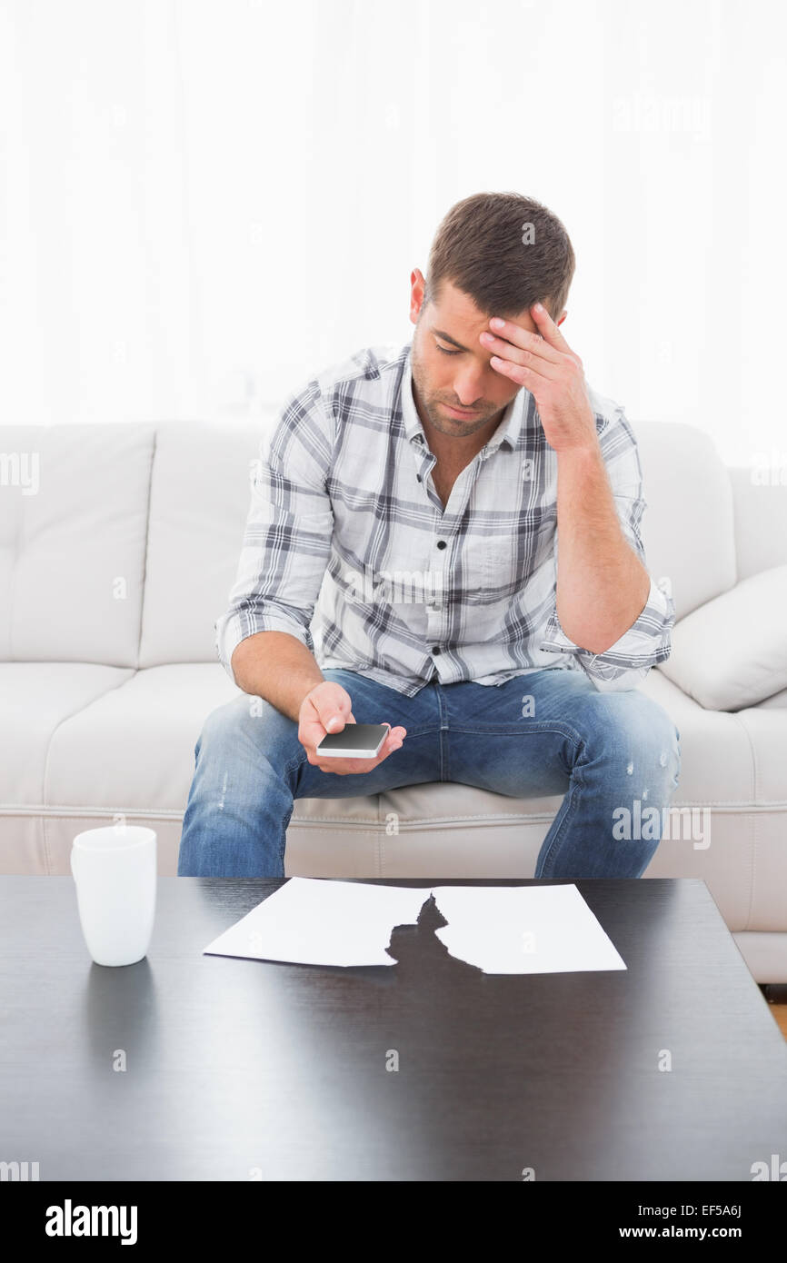 A troubled man looking papers Stock Photo - Alamy