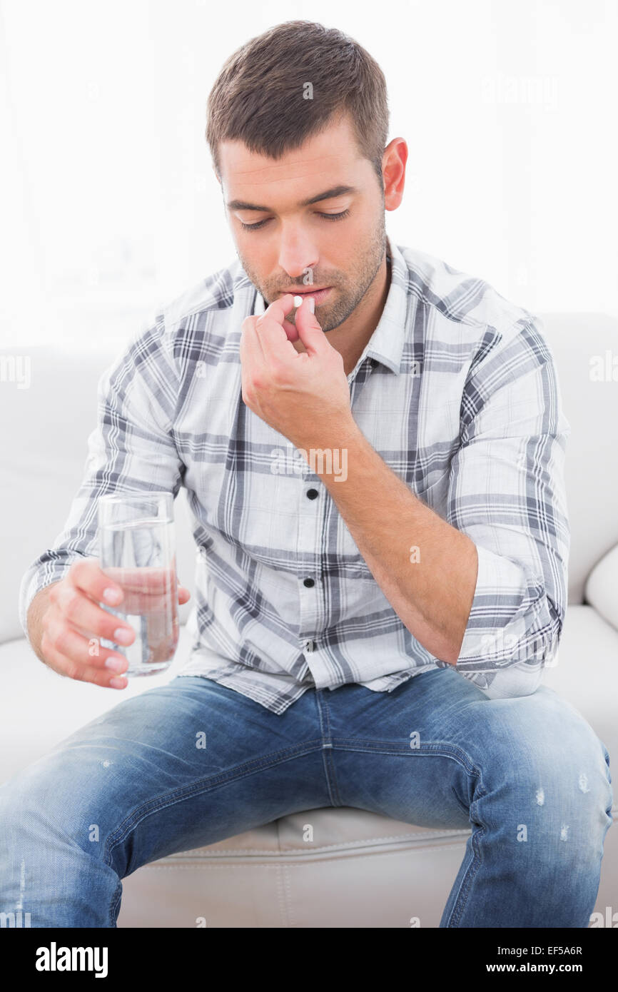 Hungover man with his medicine laid out on coffee table Stock Photo - Alamy