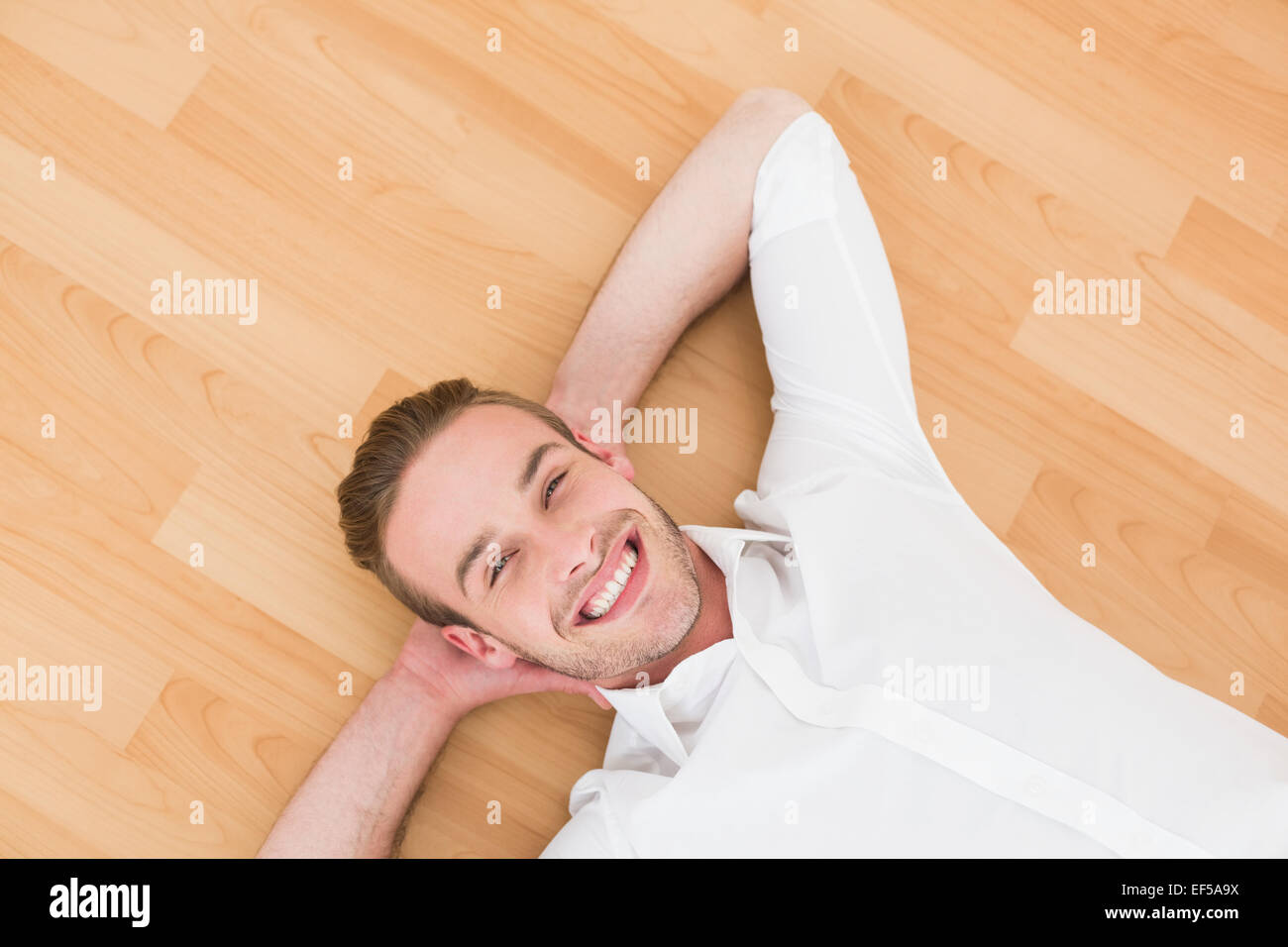 A man lying on floor at home Stock Photo - Alamy