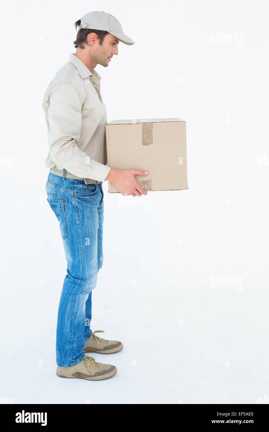 Delivery man carrying cardboard box Stock Photo - Alamy