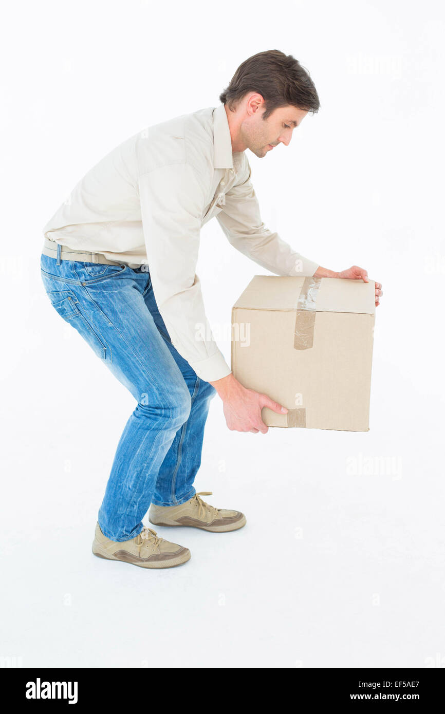 Delivery man picking cardboard box Stock Photo - Alamy