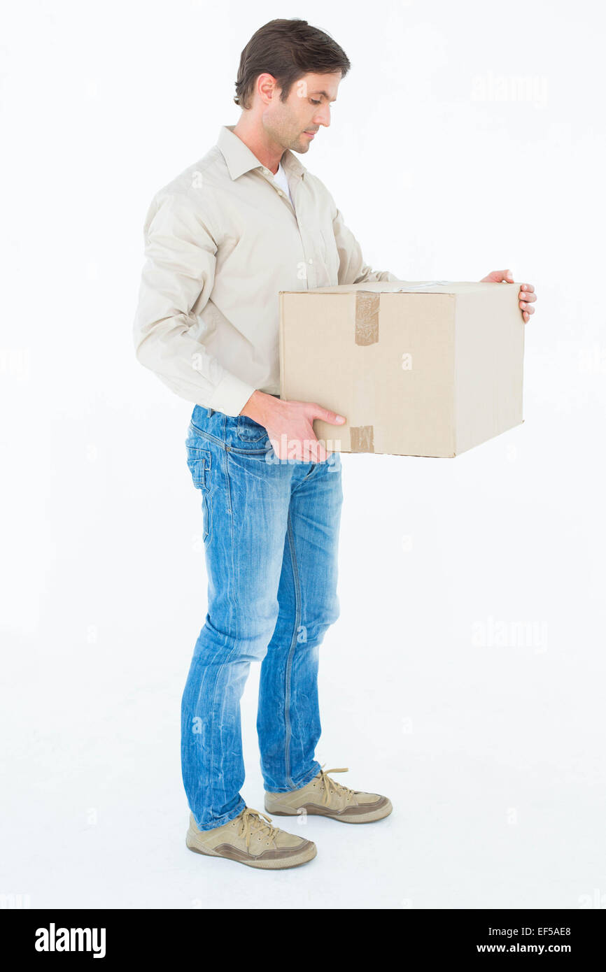 Delivery man carrying cardboard box Stock Photo - Alamy