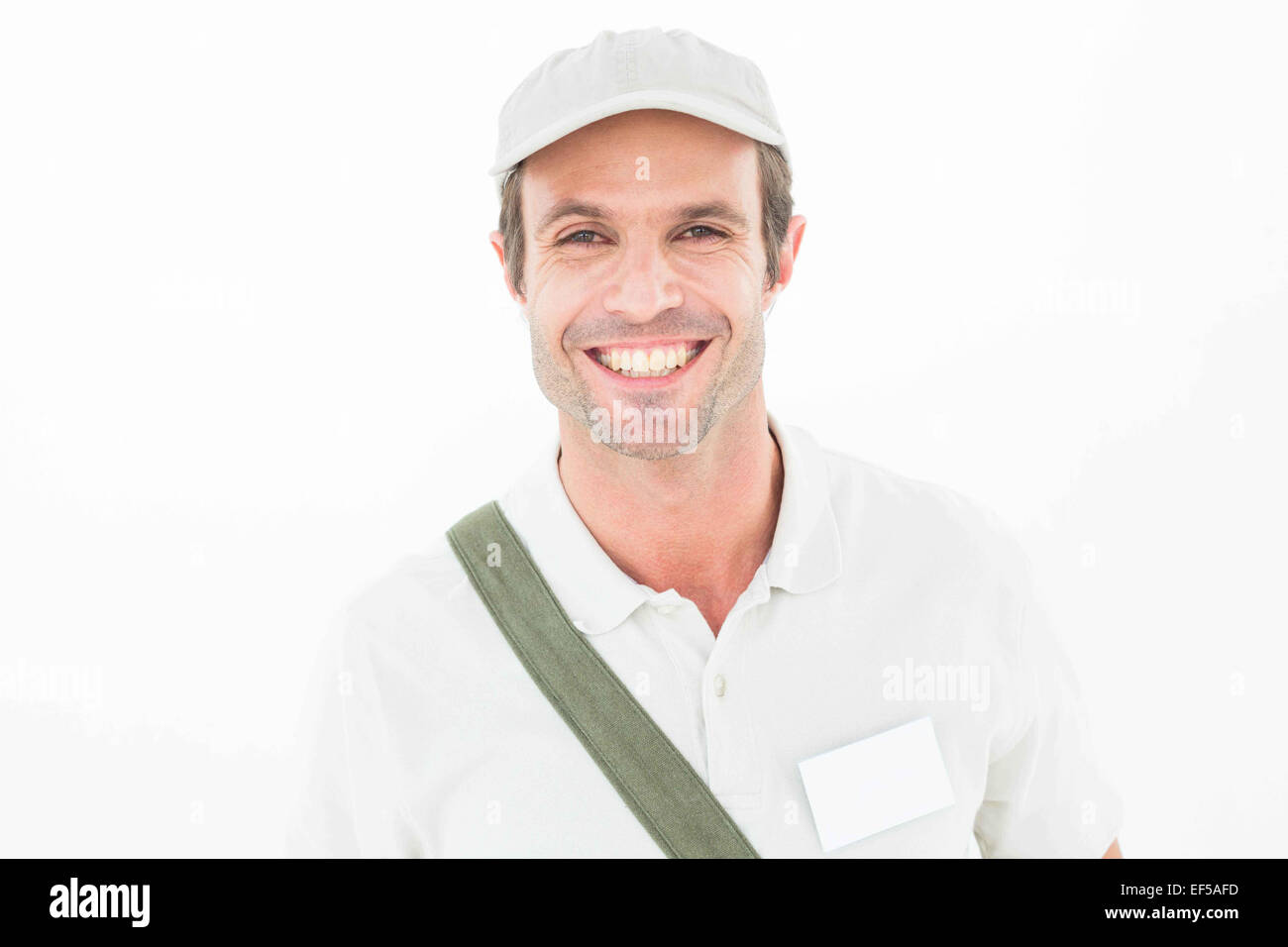 Smiling delivery man wearing cap Stock Photo - Alamy
