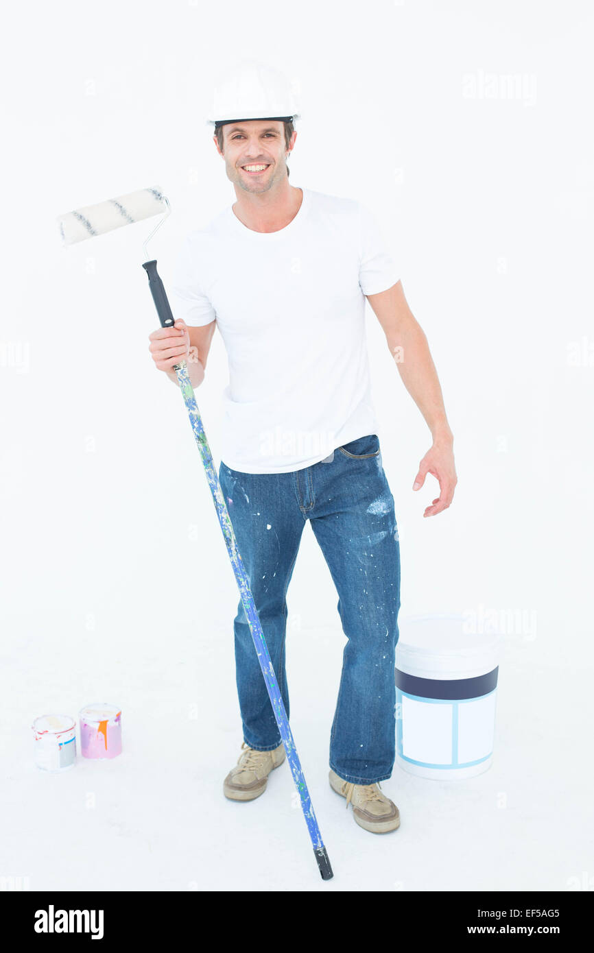 Portrait of happy man holding paint roller Stock Photo - Alamy