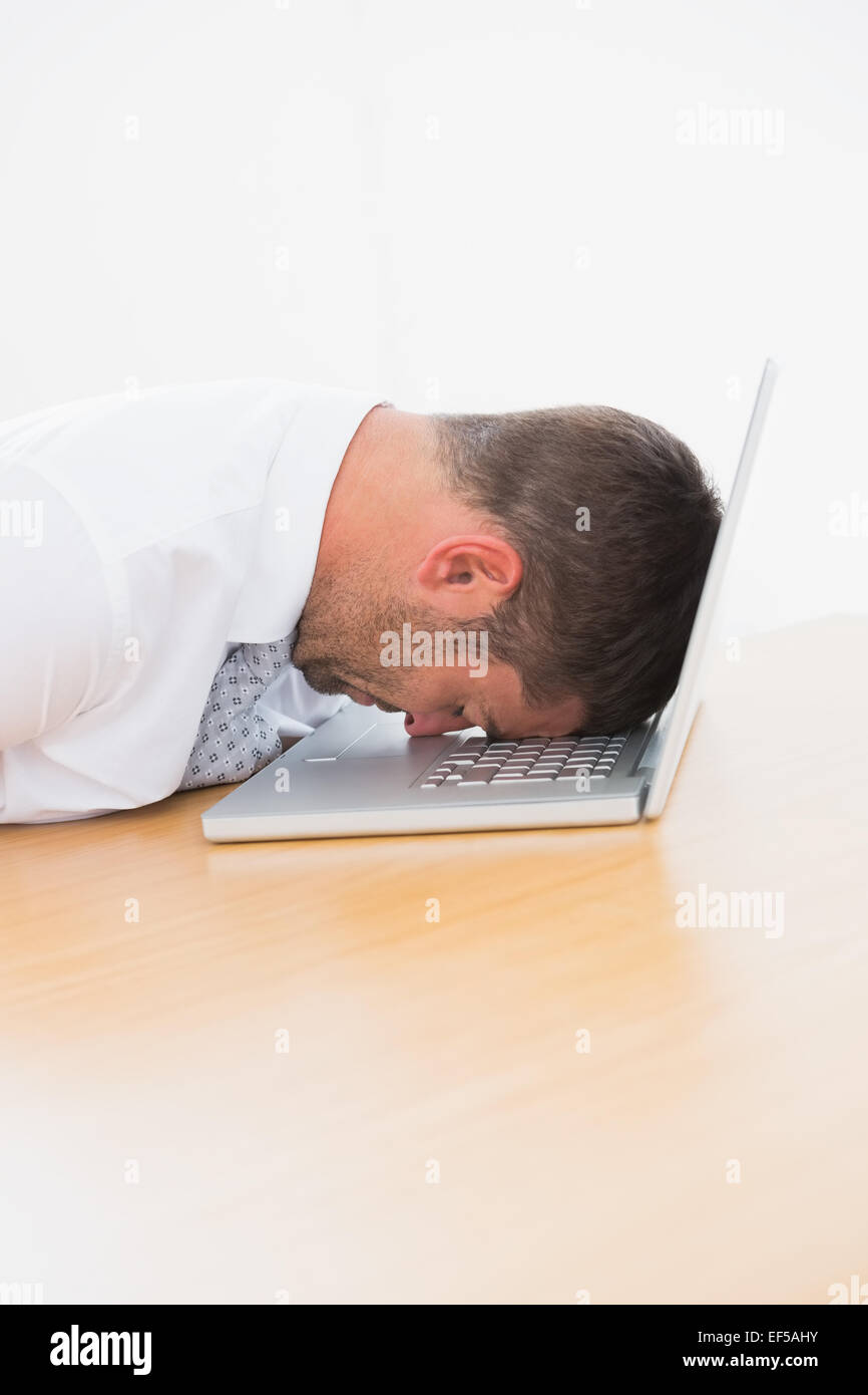 Businessman sleeping in his computer Stock Photo - Alamy